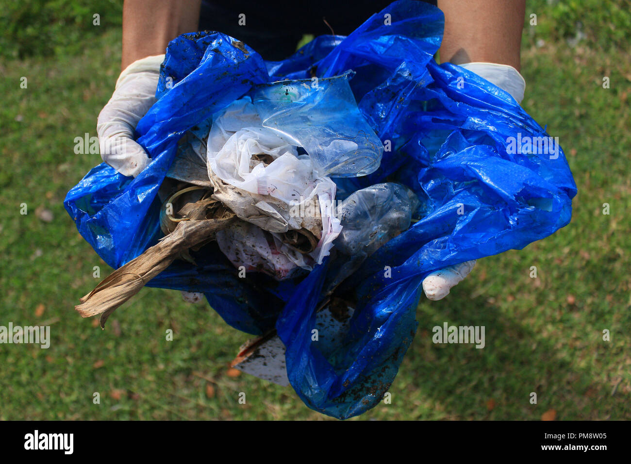 A volunteer show plastic waste that he picked up from the road side ...