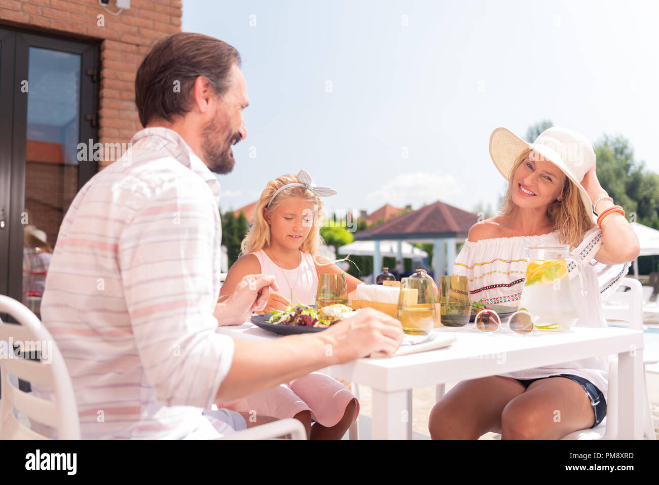 Delighted positive family sitting together at the table Stock Photo - Alamy
