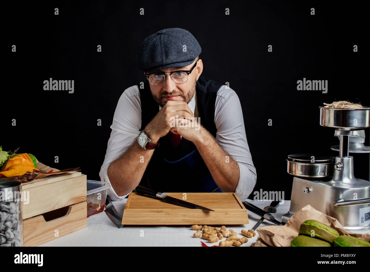 Restaurant Chef looking confidently at camera over black background ...