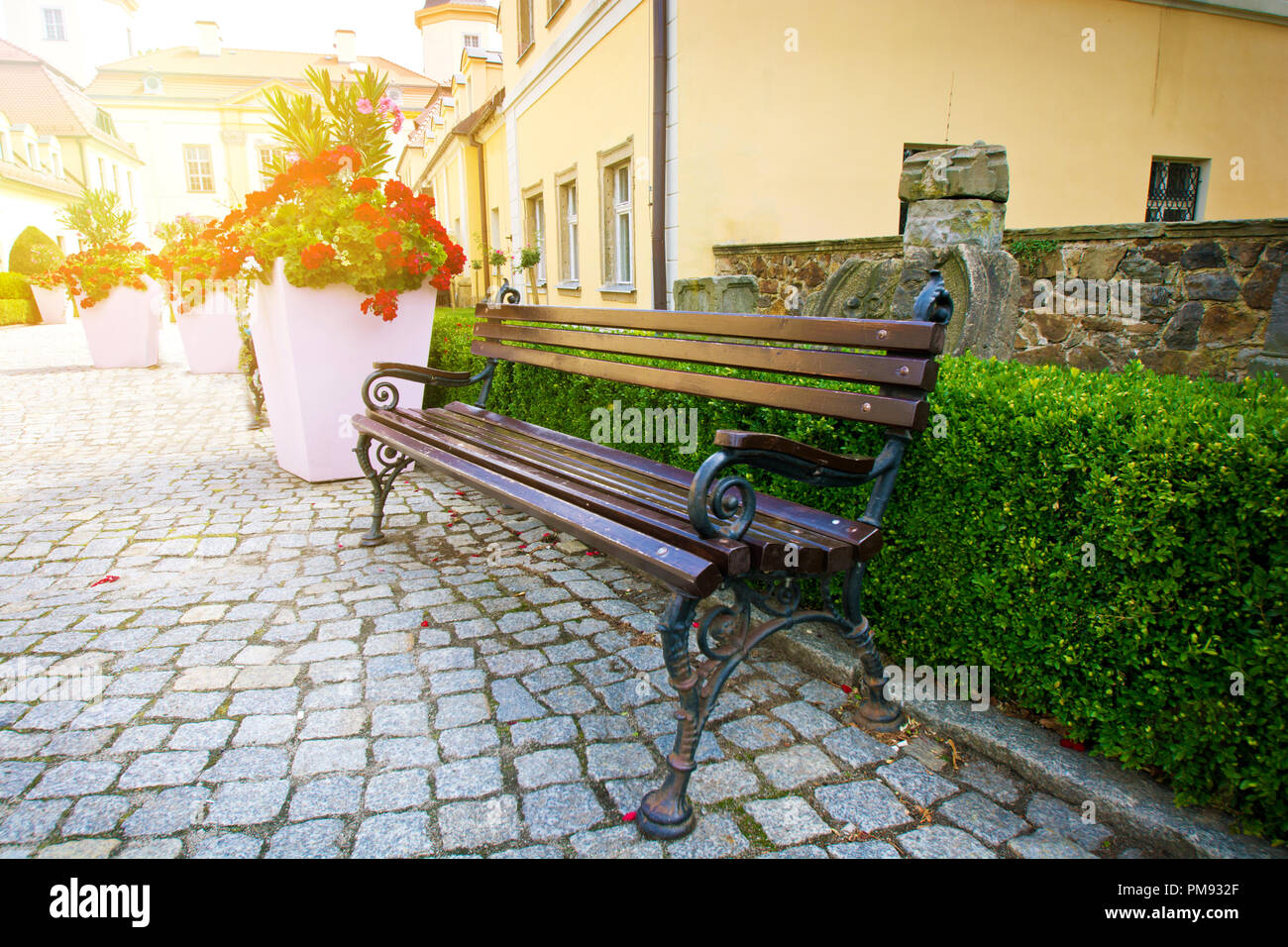 Bench in beautiful green park with flowers Stock Photo - Alamy