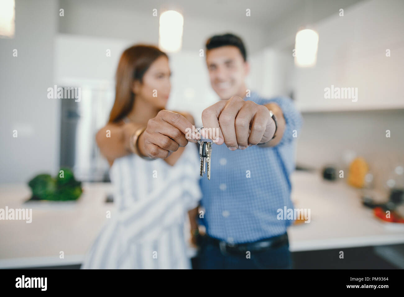 man and woman with keys Stock Photo - Alamy