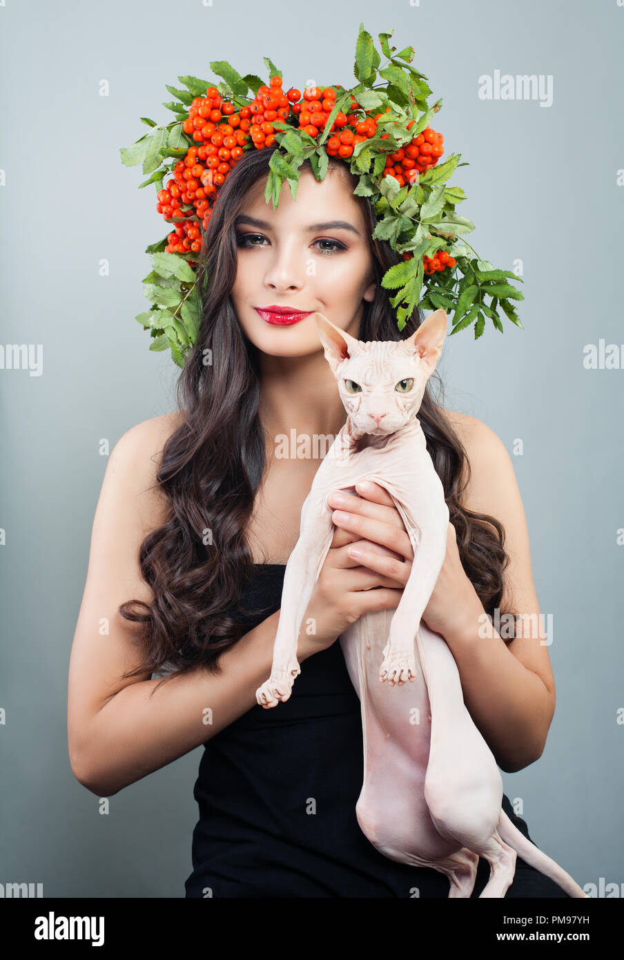 Beautiful fashion model woman with cat Stock Photo - Alamy