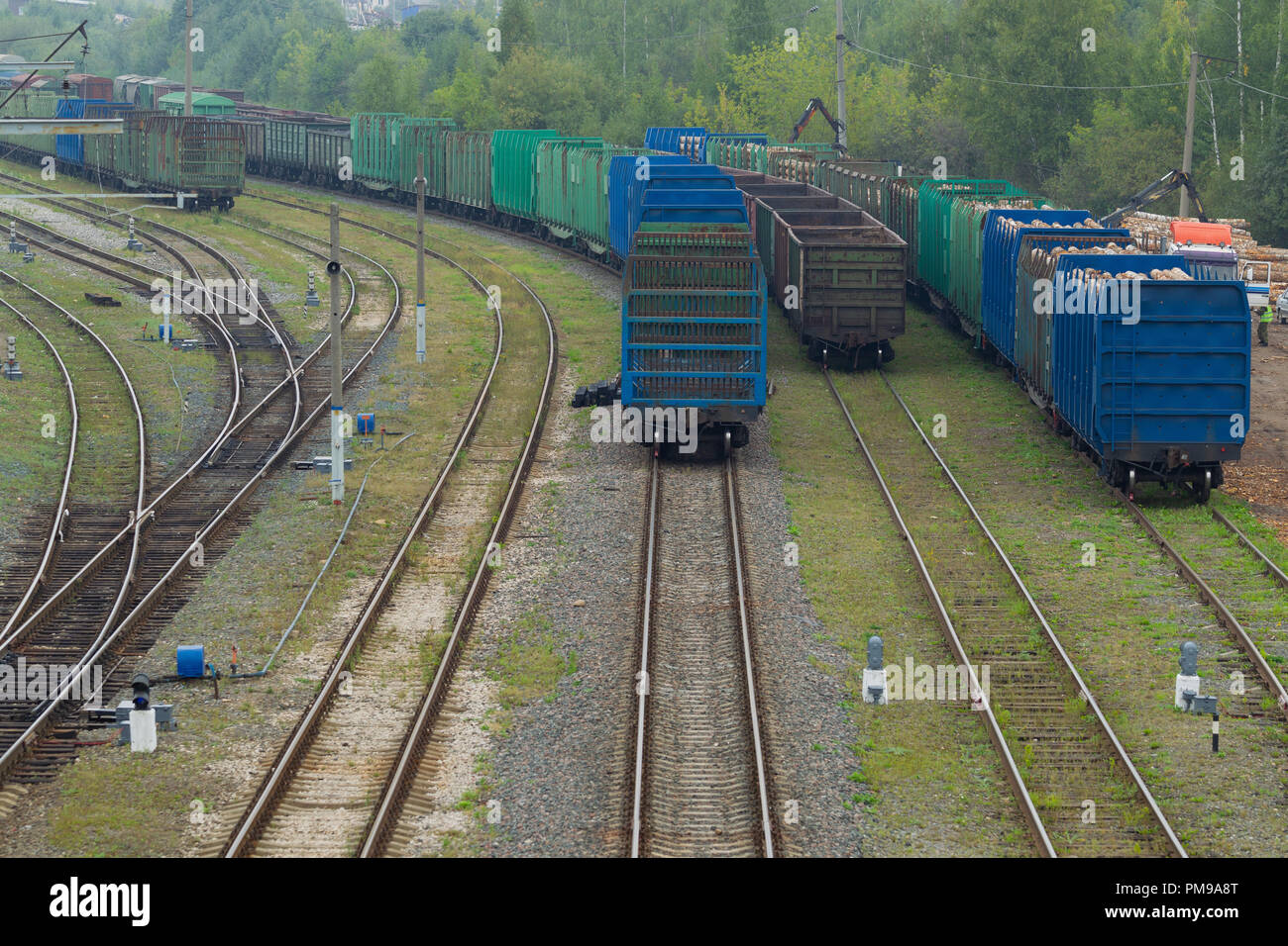 Freight trains, wagons with cargo stand on the railroad tracks of the ...