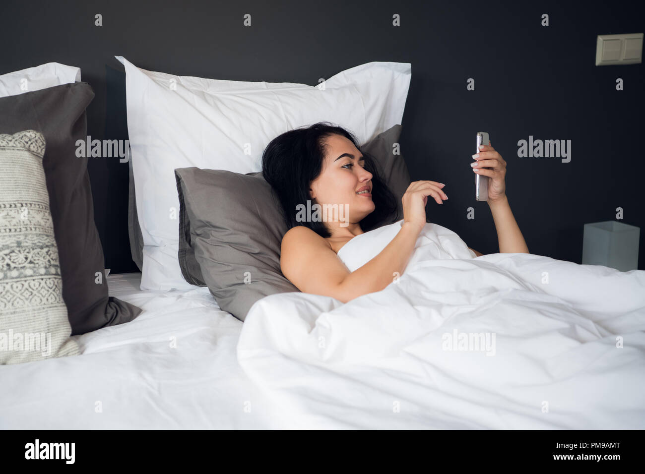 Young female connect social network with smartphone in the morning, she ...
