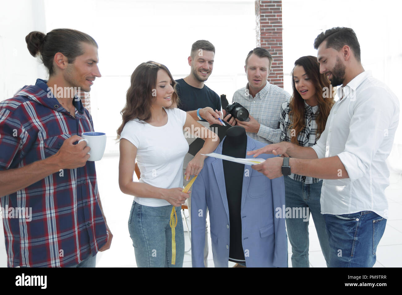designers working with new models of men's clothing Stock Photo - Alamy