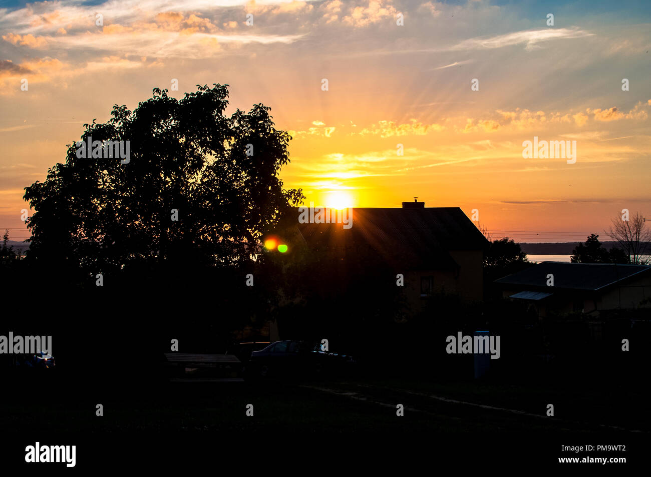 Sun breaking through the house, rays of sun, clouds Stock Photo - Alamy