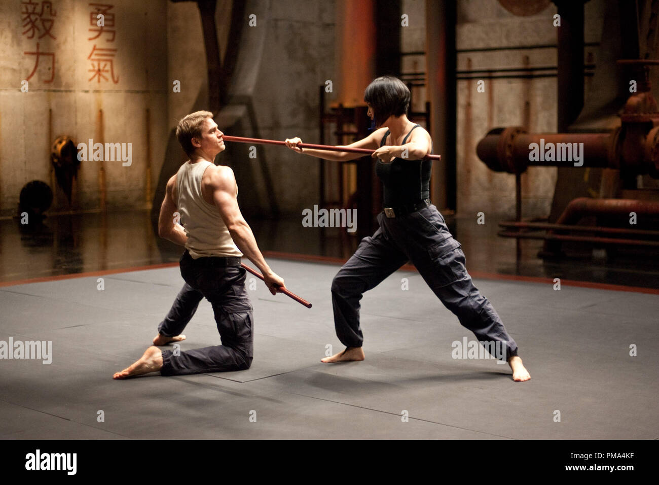 (L-r) CHARLIE HUNNAM as Raleigh Becket and RINKO KIKUCHI as Mako Mori ...