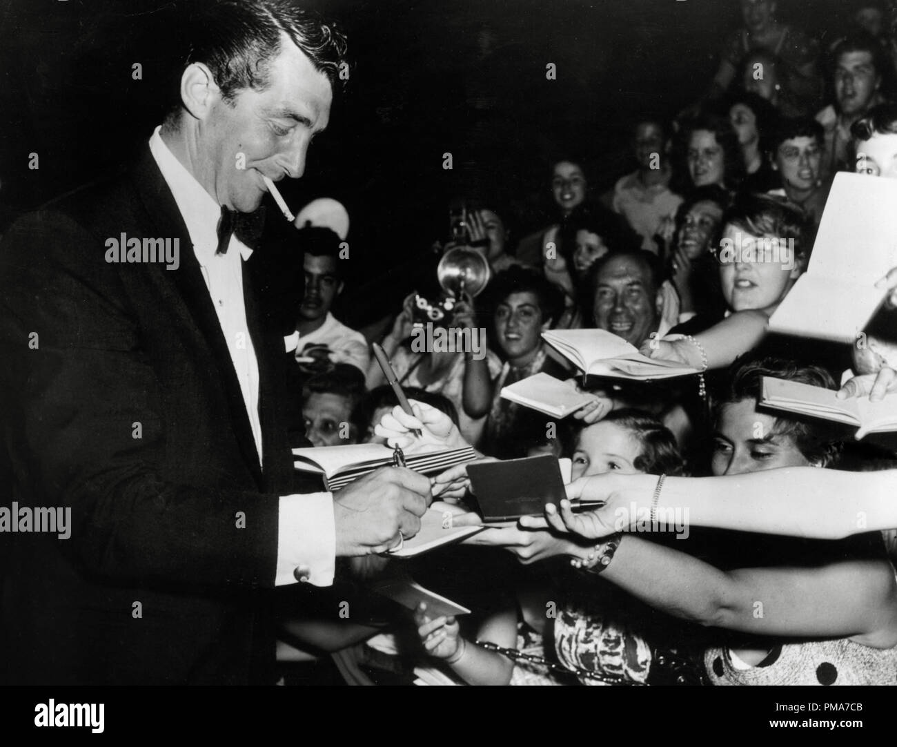 Dean Martin signing autographs at the premiere of "King Richard and the ...