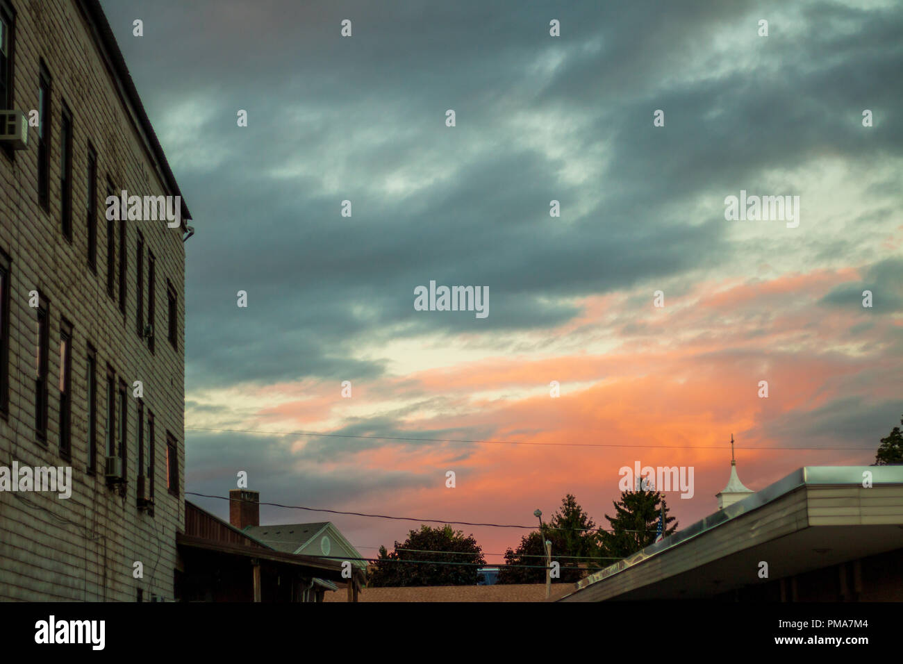 a pink sky at dusk from a small town Stock Photo - Alamy