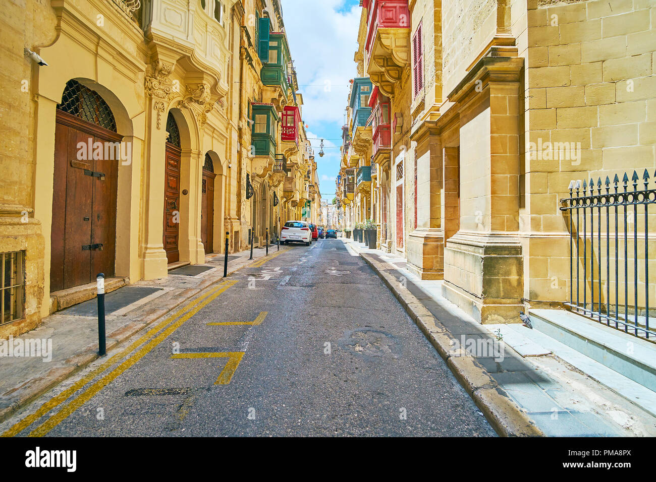 The native limestone edifices line the St Paul street in old Valletta ...