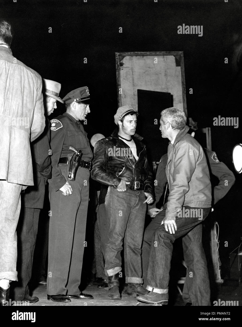 Film Still/Publicity Still of "The Wild One" Marlon Brando behind the ...