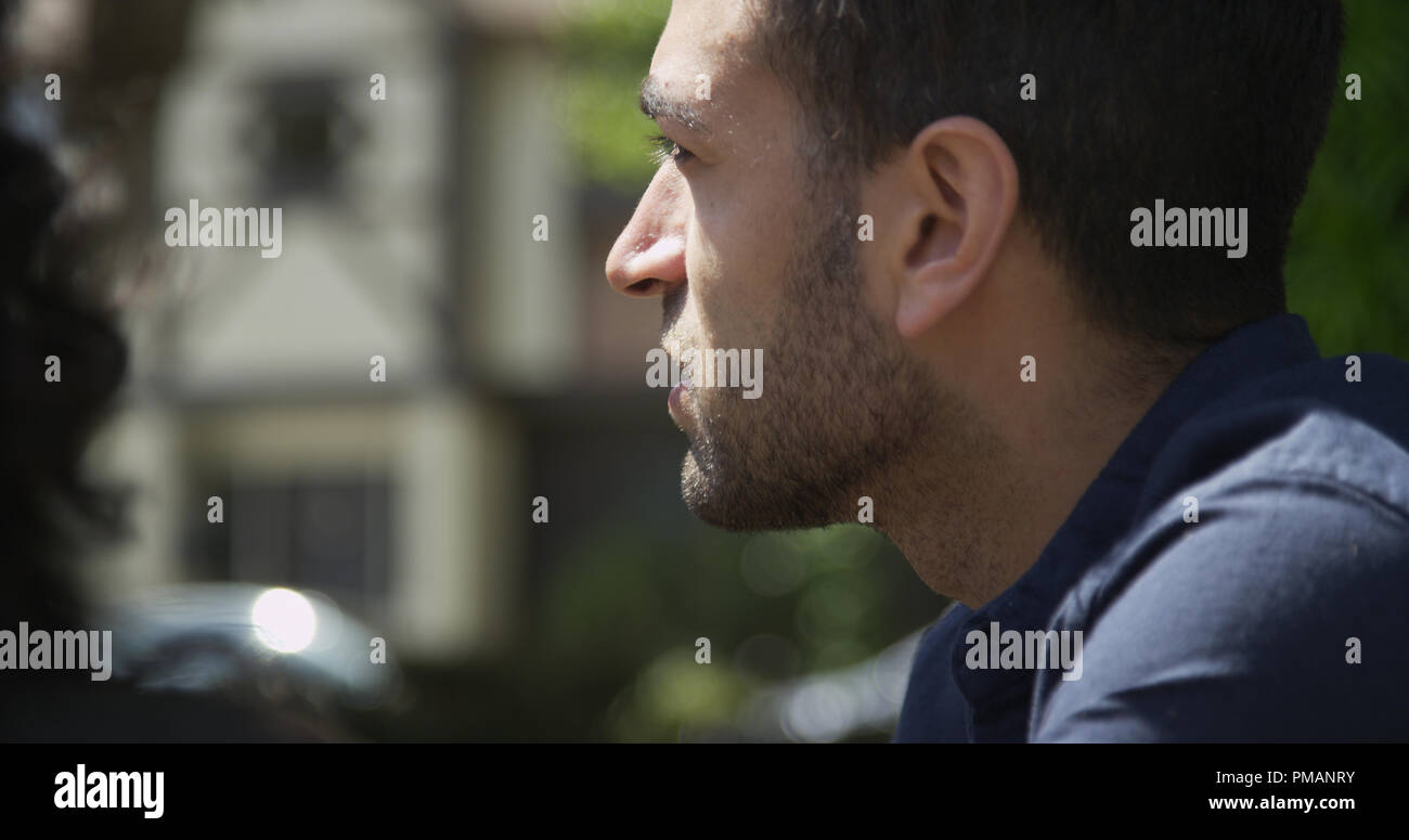 Profile of hispanic man in the park Stock Photo - Alamy