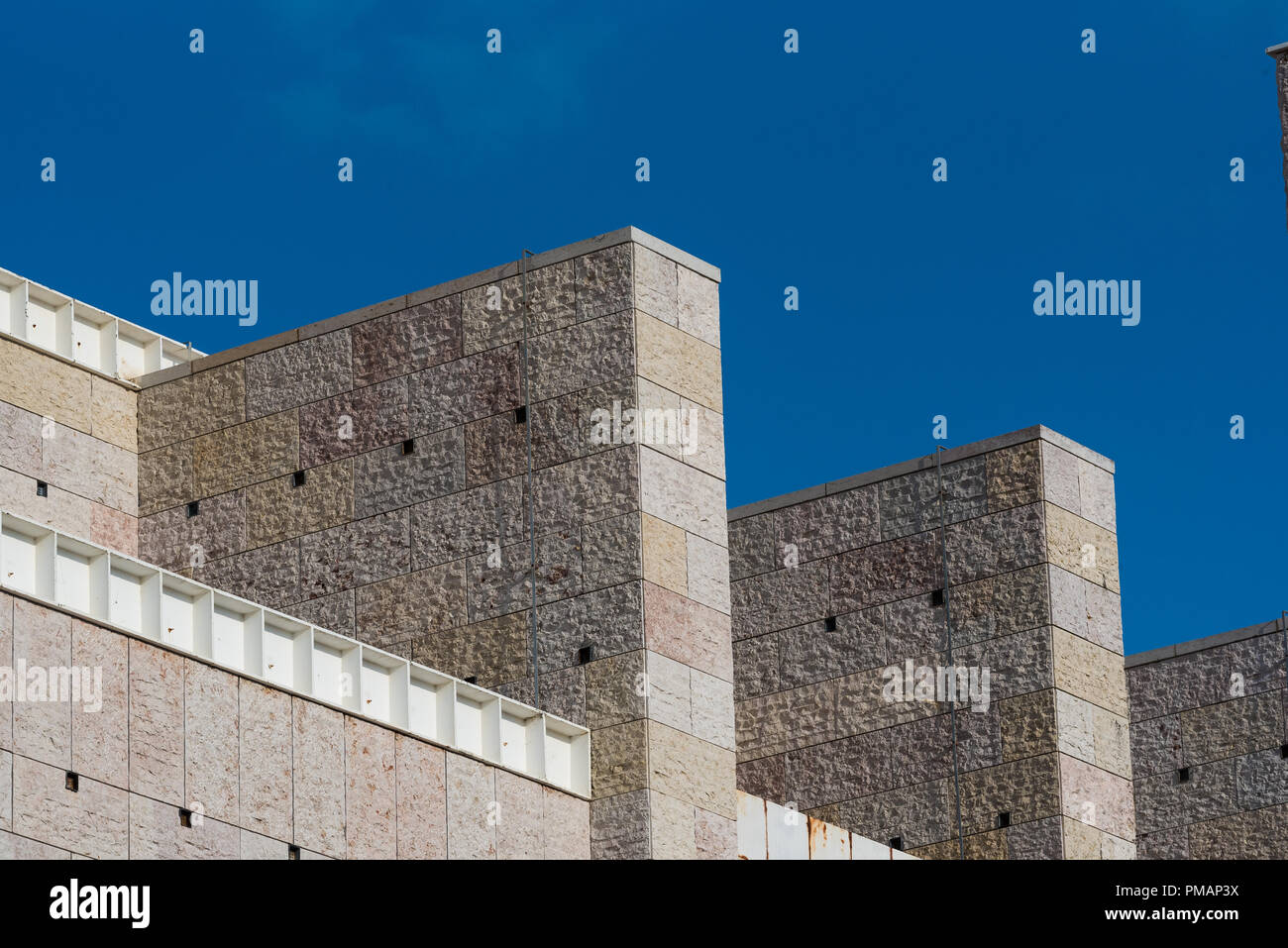 Parapet details of modern architecture public building facade made of natural stone tiles and ...