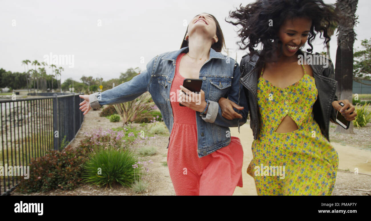Two happy best friends walking side by side Stock Photo - Alamy