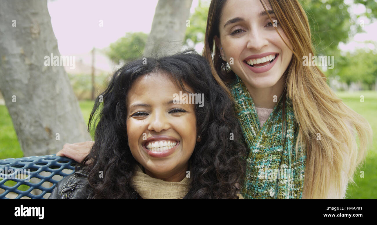 Women smiling and laughing looking at camera outdoors Stock Photo - Alamy