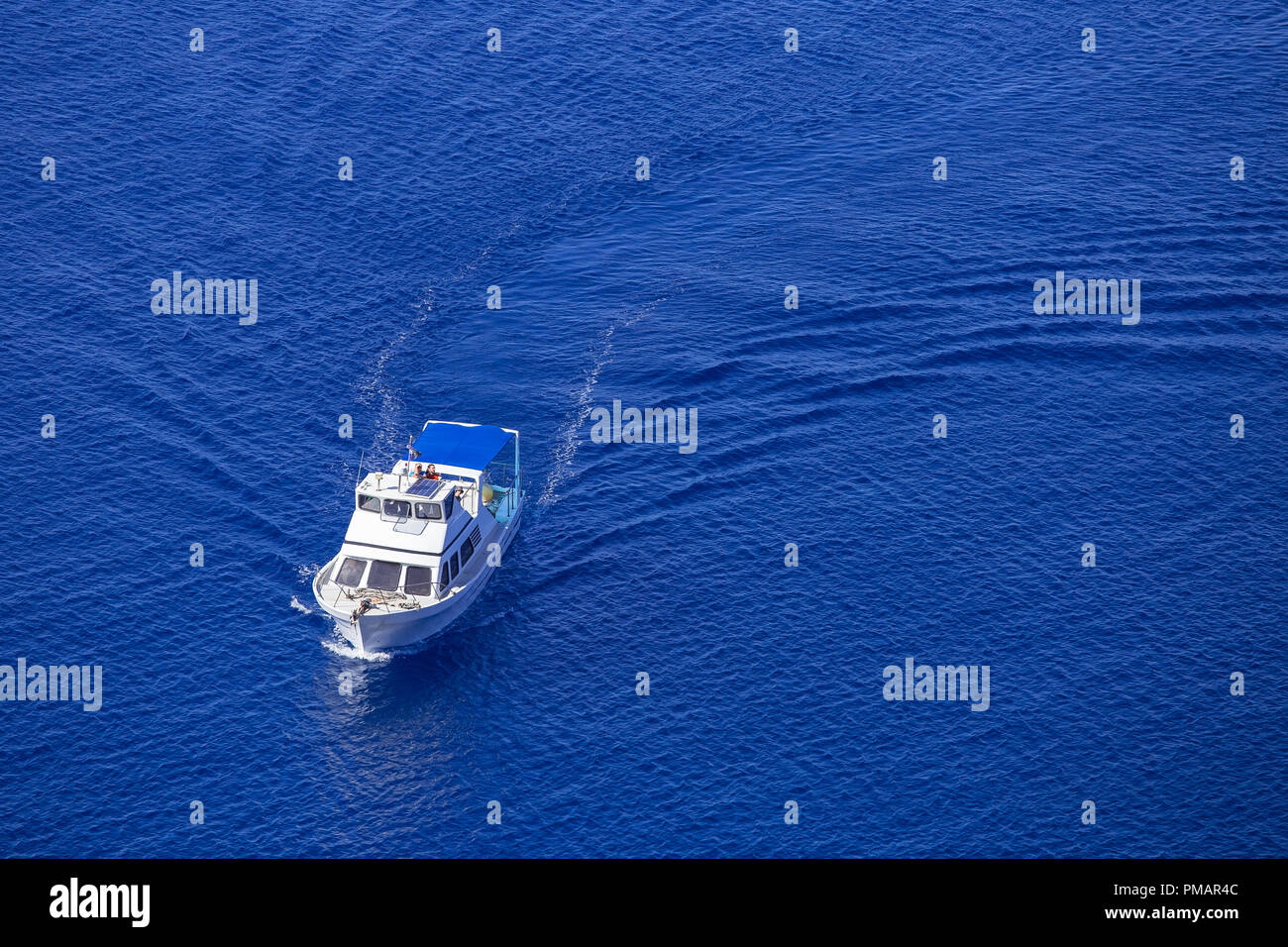 Little boat in the blue ocean with its waves Stock Photo - Alamy
