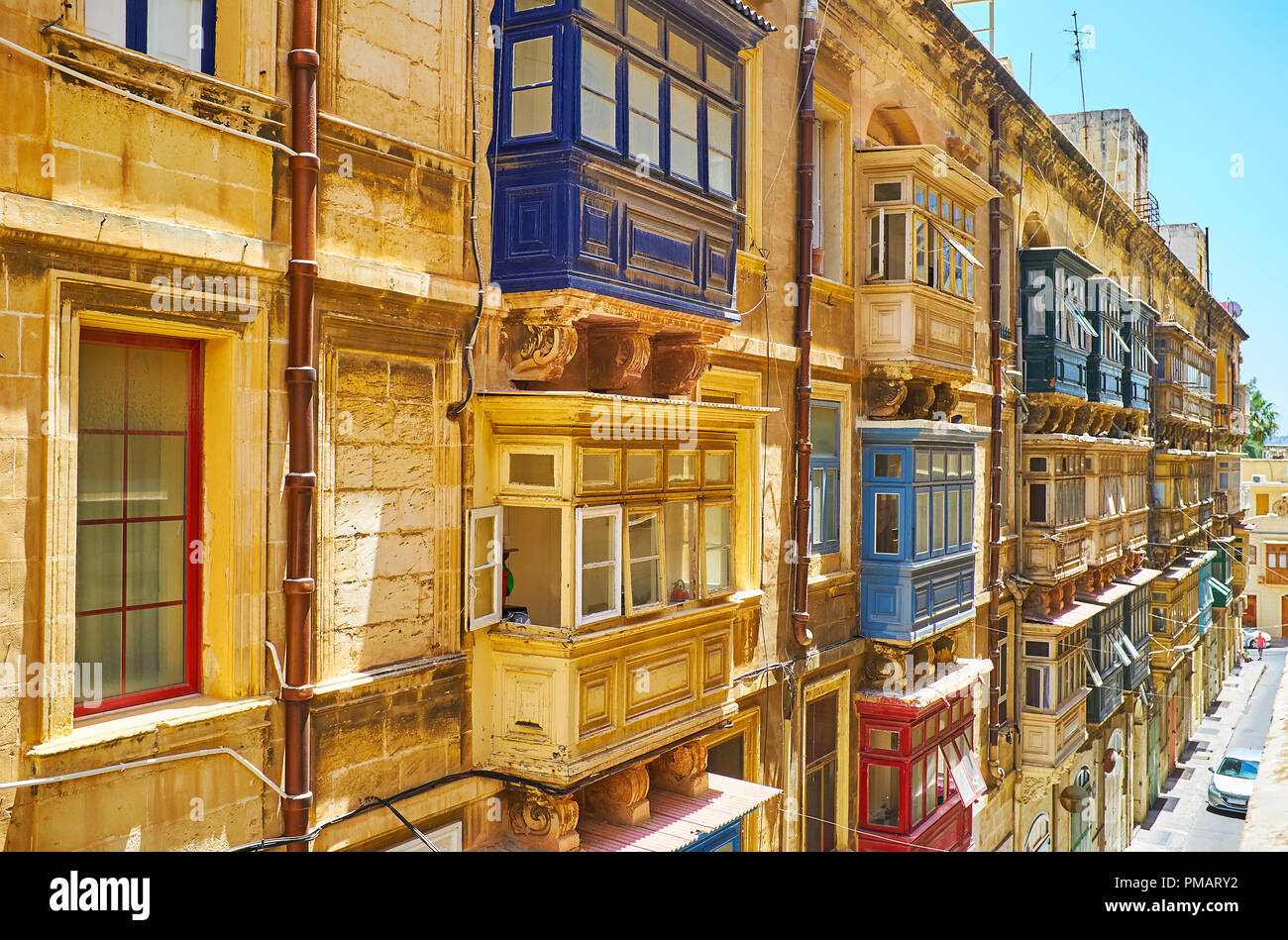 Observe traditional wooden Maltese balconies, typical for historical ...