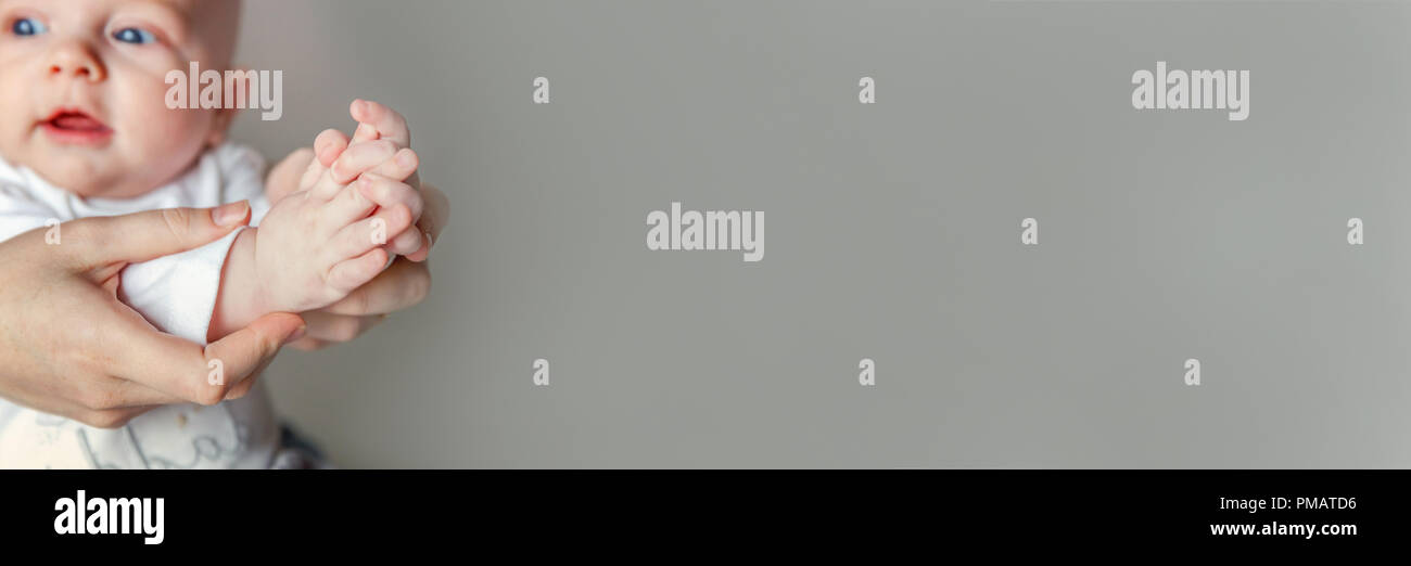 Young mother and newborn child clap their hands. Woman and infant new ...