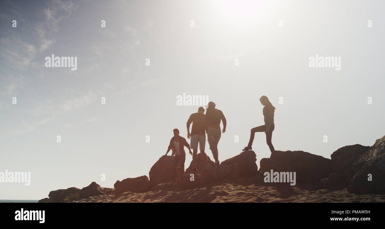 Silhouette friends walking on rocks hi-res stock photography and images ...