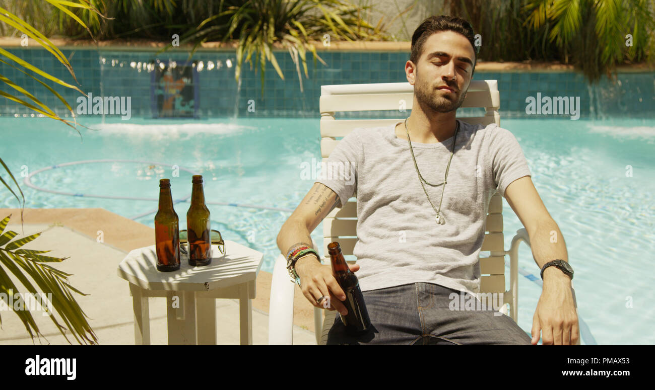 Mexican man taking a nap outdoors by the pool Stock Photo - Alamy