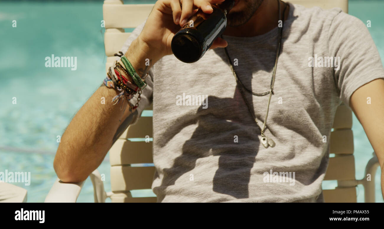 Mexican man sunbathing by the pool Stock Photo - Alamy