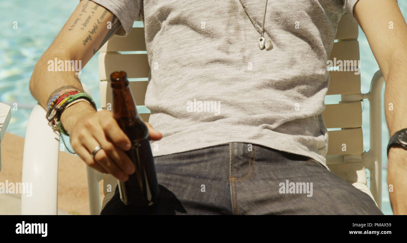 Hispanic man sunbathing pool hi-res stock photography and images - Alamy