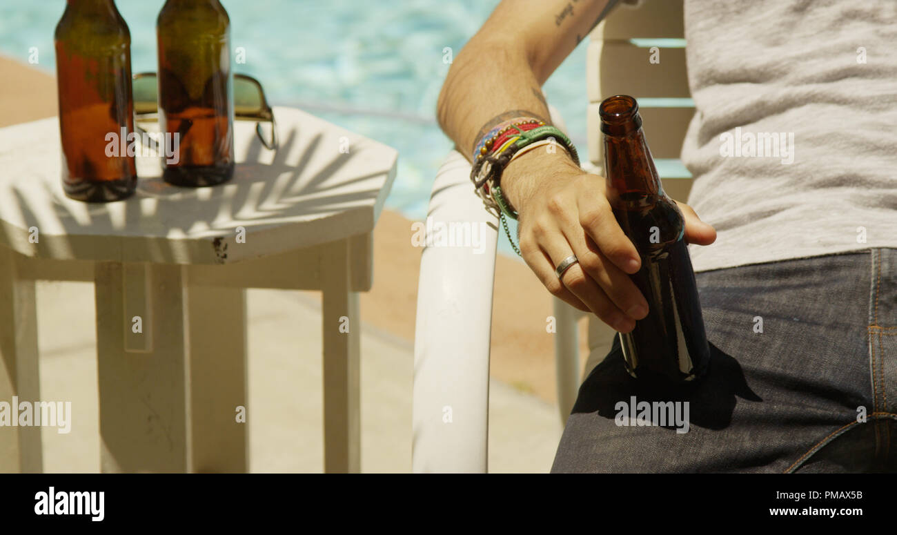 Tired Mexican man sunbathing by the pool Stock Photo - Alamy