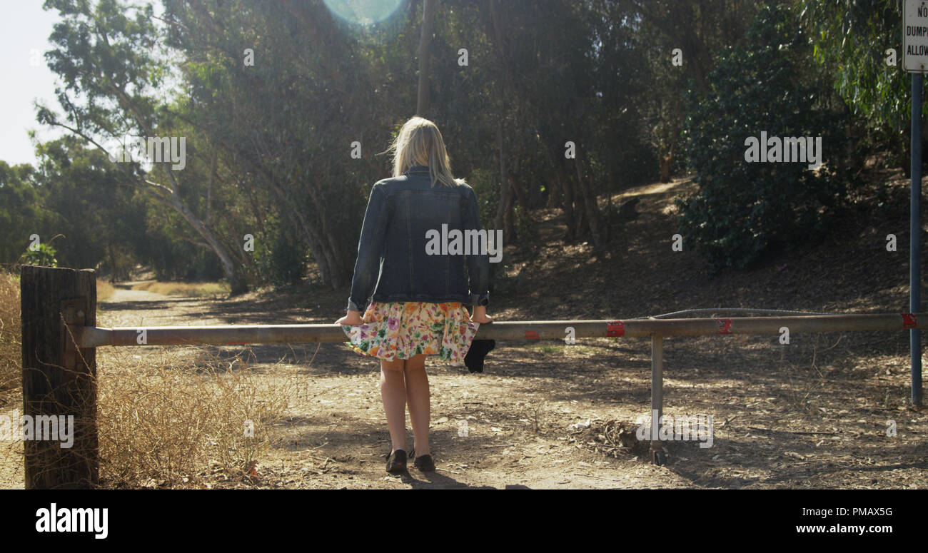 Pretty white hipster girl sitting on a gate outdoors Stock Photo - Alamy