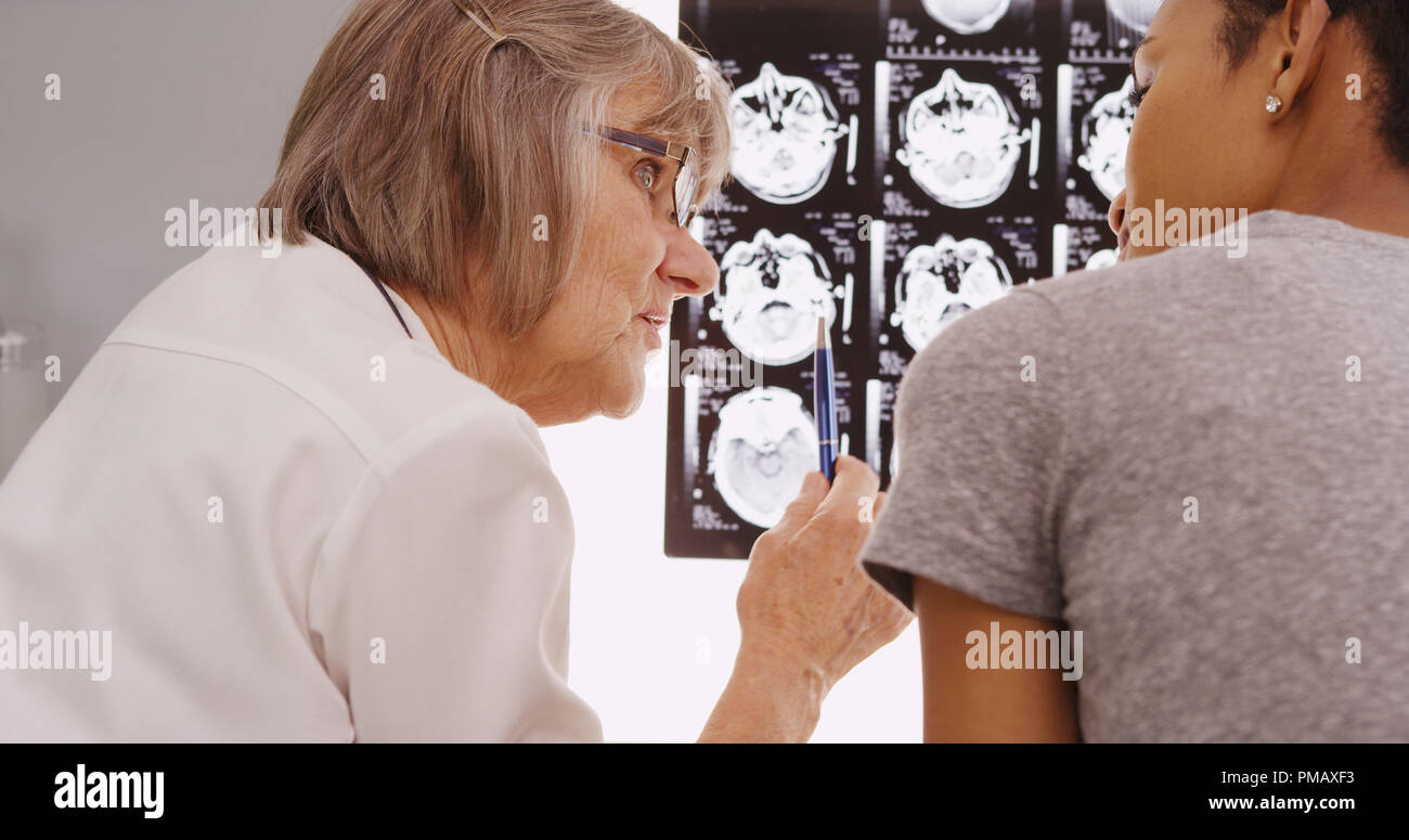 Mature radiologist reviewing x-ray results with patient Stock Photo - Alamy