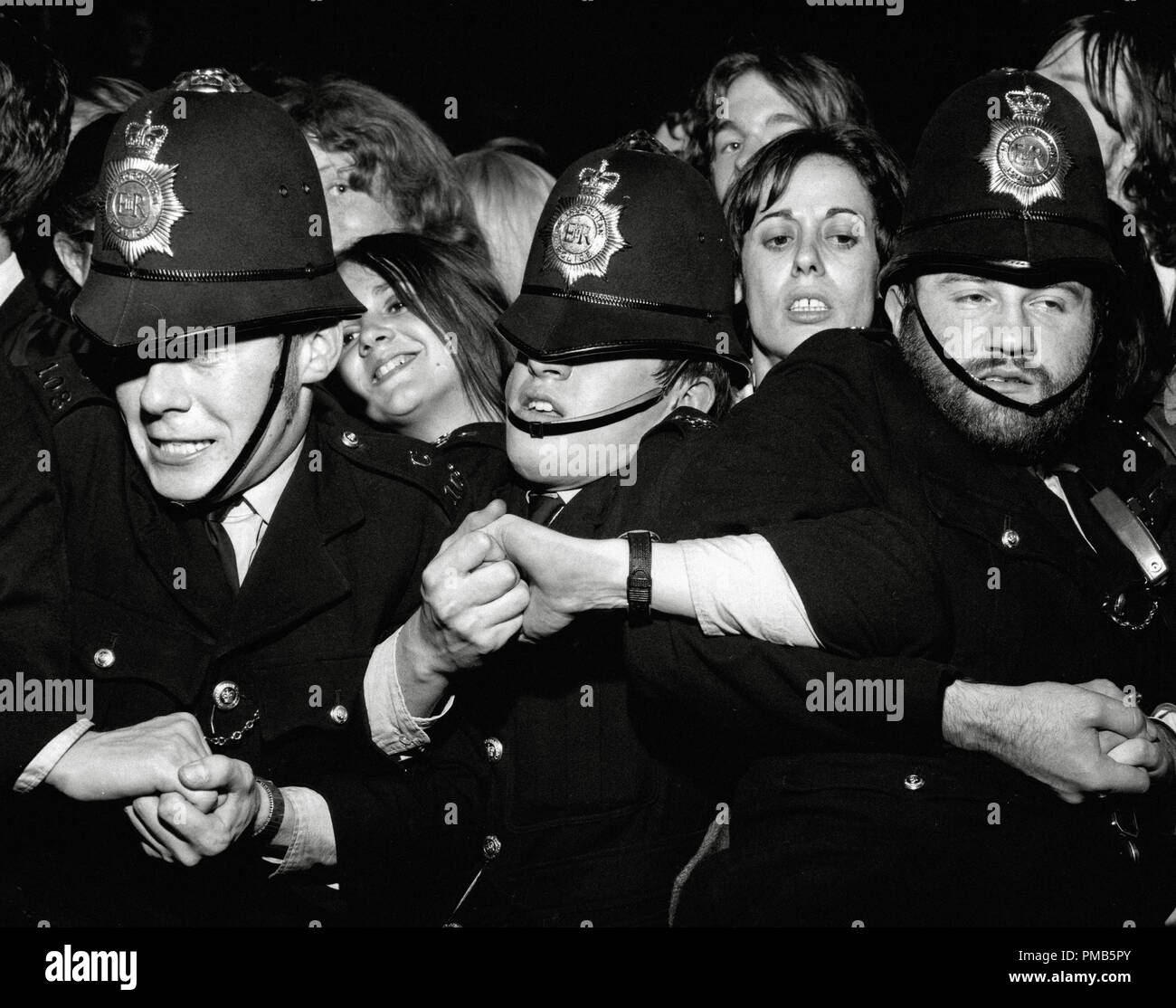 London police holding back crowds outside the London Pavillion during ...