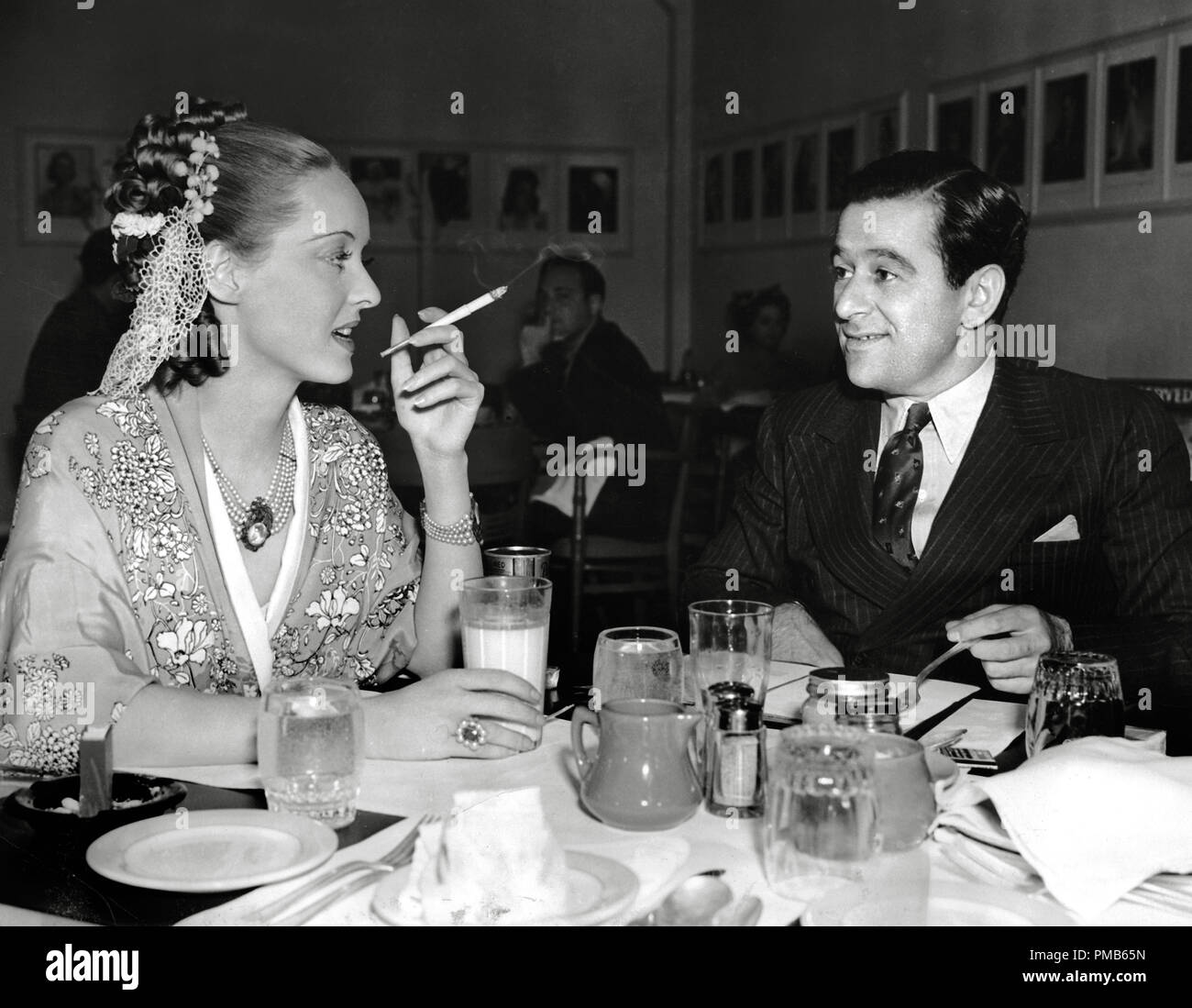 Bette Davis and director William Wyler take a break during filming ...