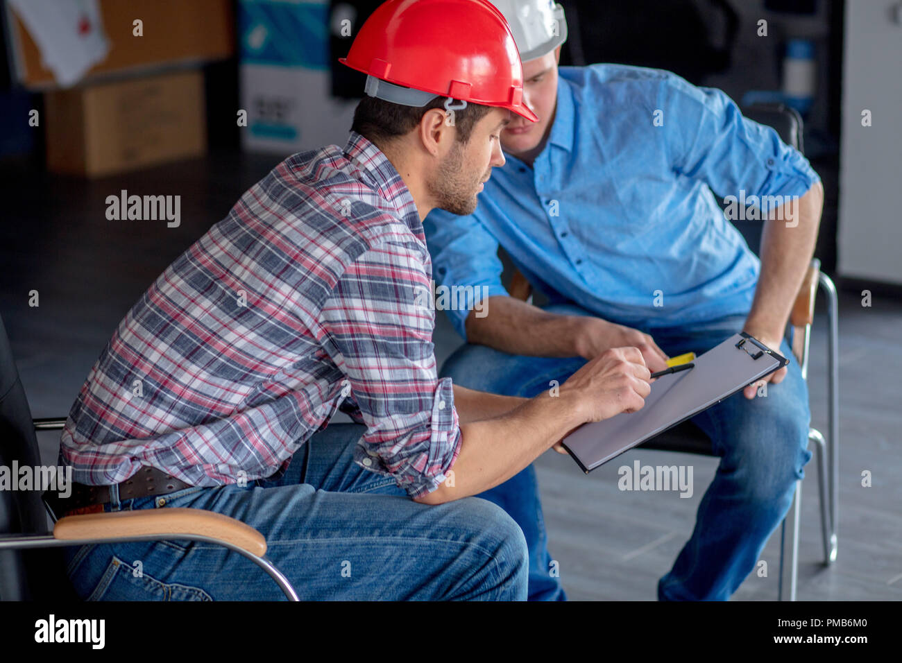 two constructors doing the correction of business project Stock Photo ...