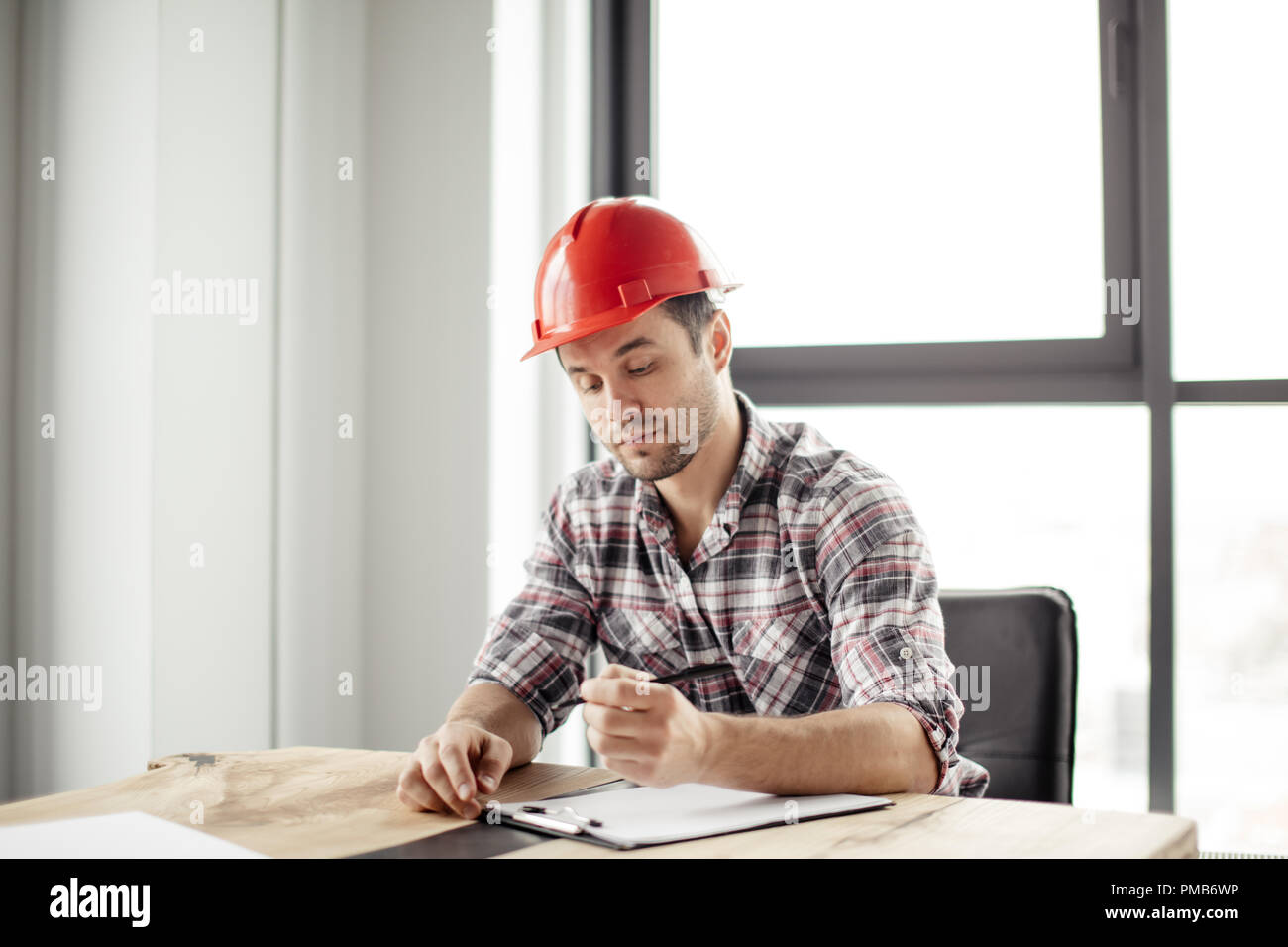 industrial engineer writing something on notepad Stock Photo - Alamy