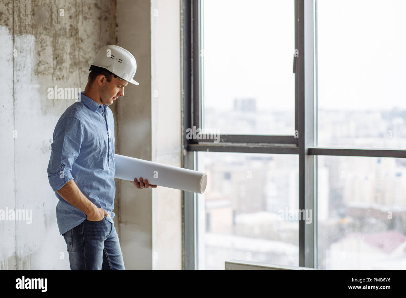 upset builder is looking down Stock Photo - Alamy