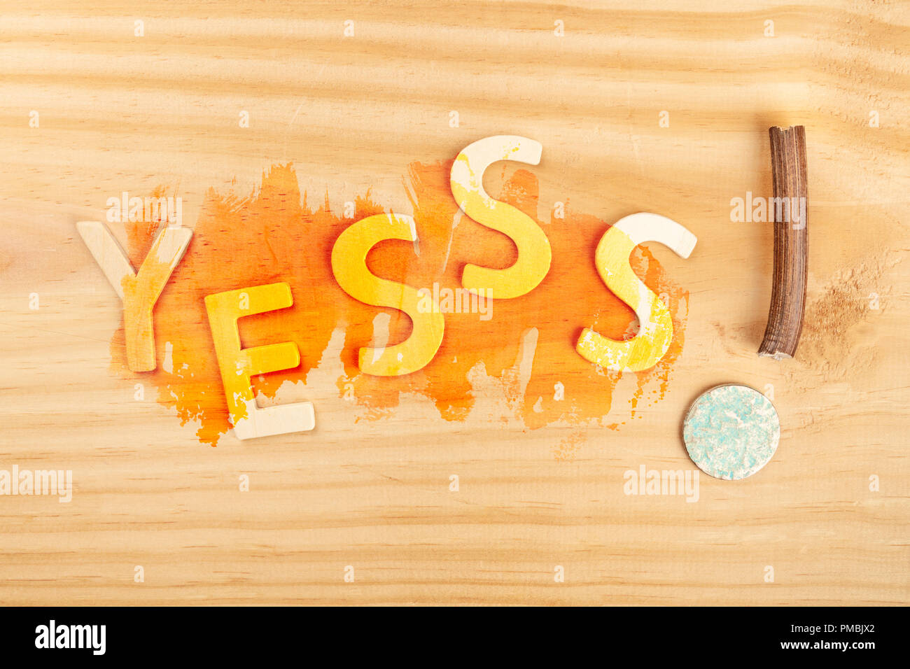 Yes, painted letters forming the word on a wooden background with a ...