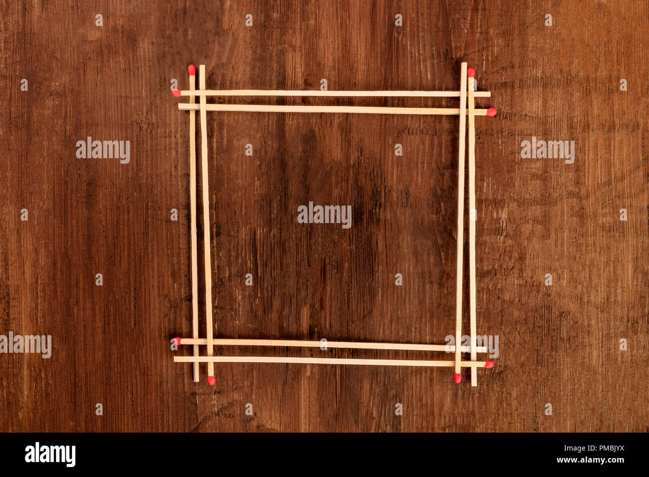 A handful of matches on a dark rustic background, forming a frame with ...