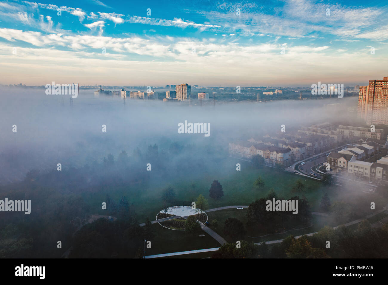 Foggy morning in Toronto city, Canada. Rays of early rising sun ...