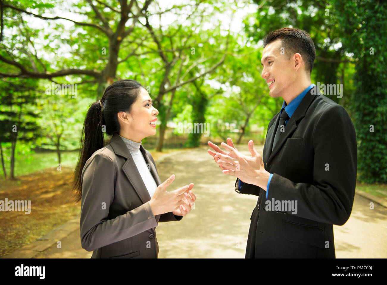 Attractive asian business people having serious conversation at outdoor ...