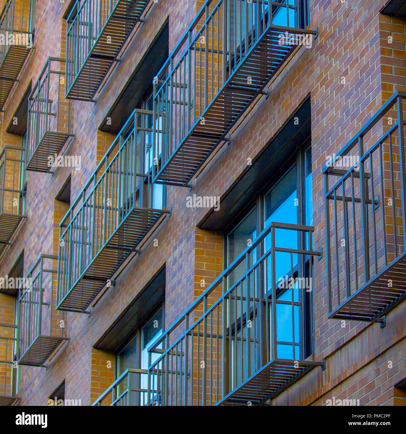 Narrow and airy balconies of a brick building. Close up view of a ...