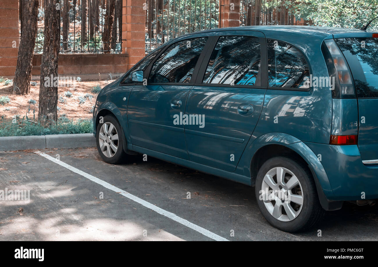 A fragment of a modern car in the Parking lot near the Park. Side view ...