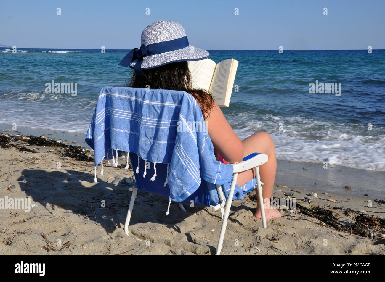 Reading a book on a beach hi-res stock photography and images - Alamy