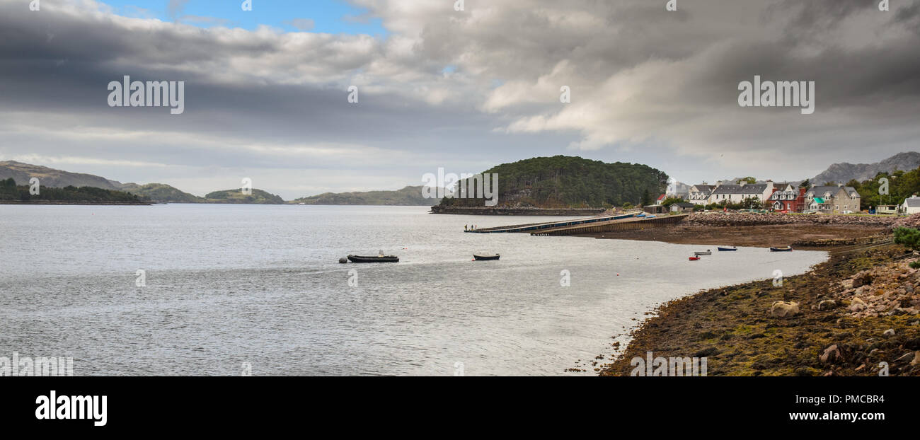 Cottages nestle on the rocky shore of Loch Torridon, an inlet of the ...