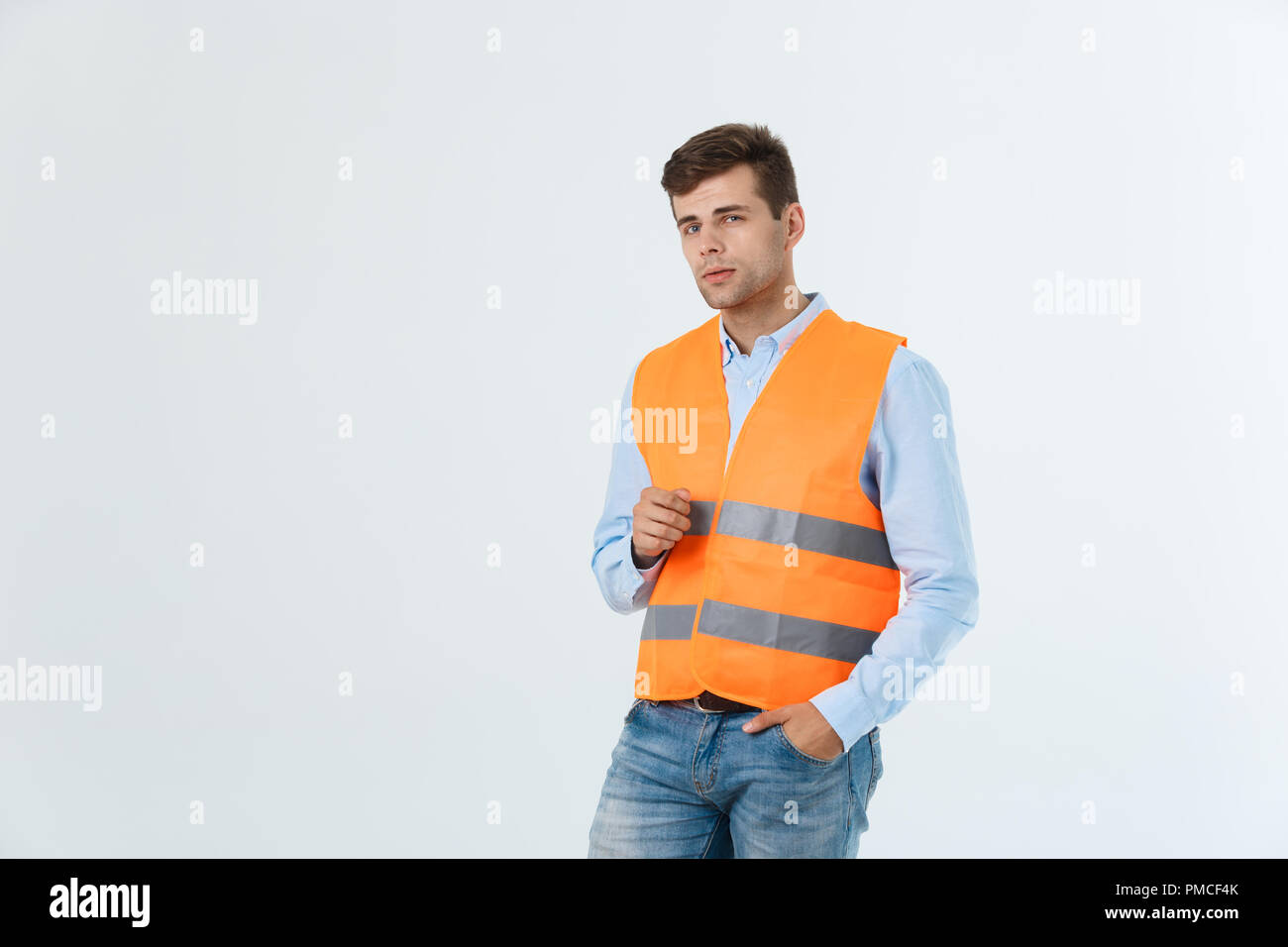 Thoughtful architect or engineer serious thinking against grey ...