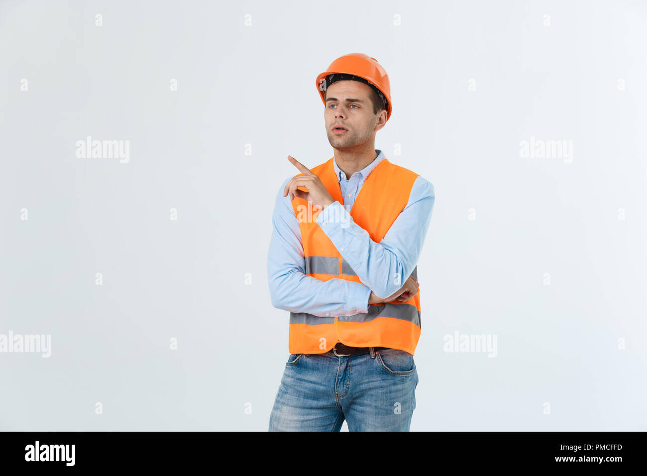 Thoughtful architect or engineer serious thinking against grey ...