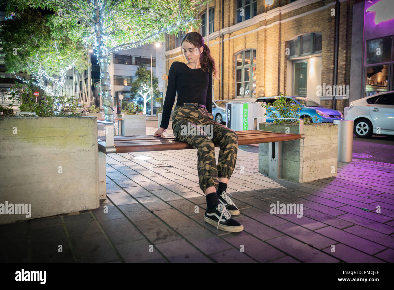 AUCKLAND, NEW ZEALAND - SEPTEMBER 14 2018; Young adult seated looking ...