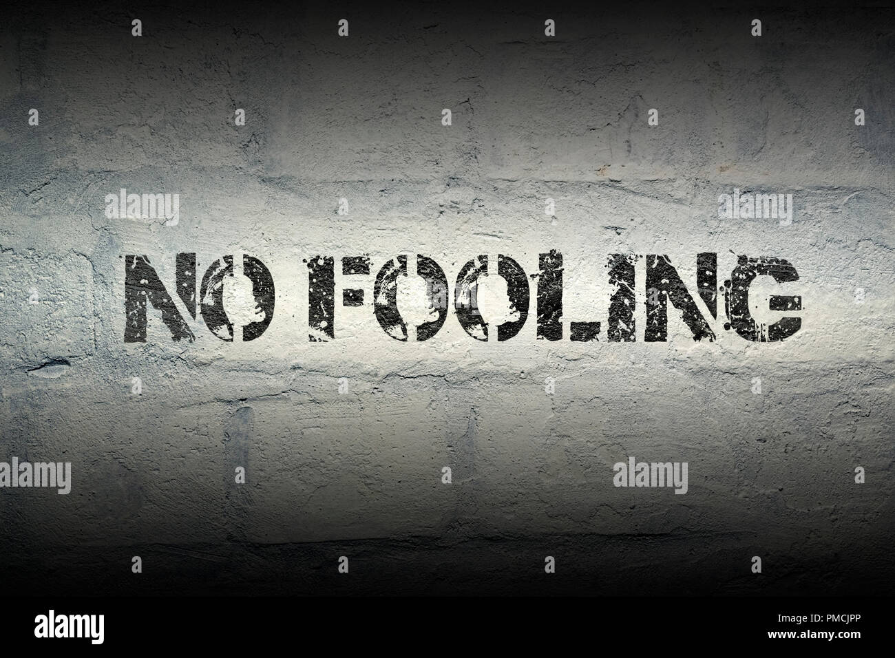 no fooling stencil print on the grunge white brick wall Stock Photo - Alamy