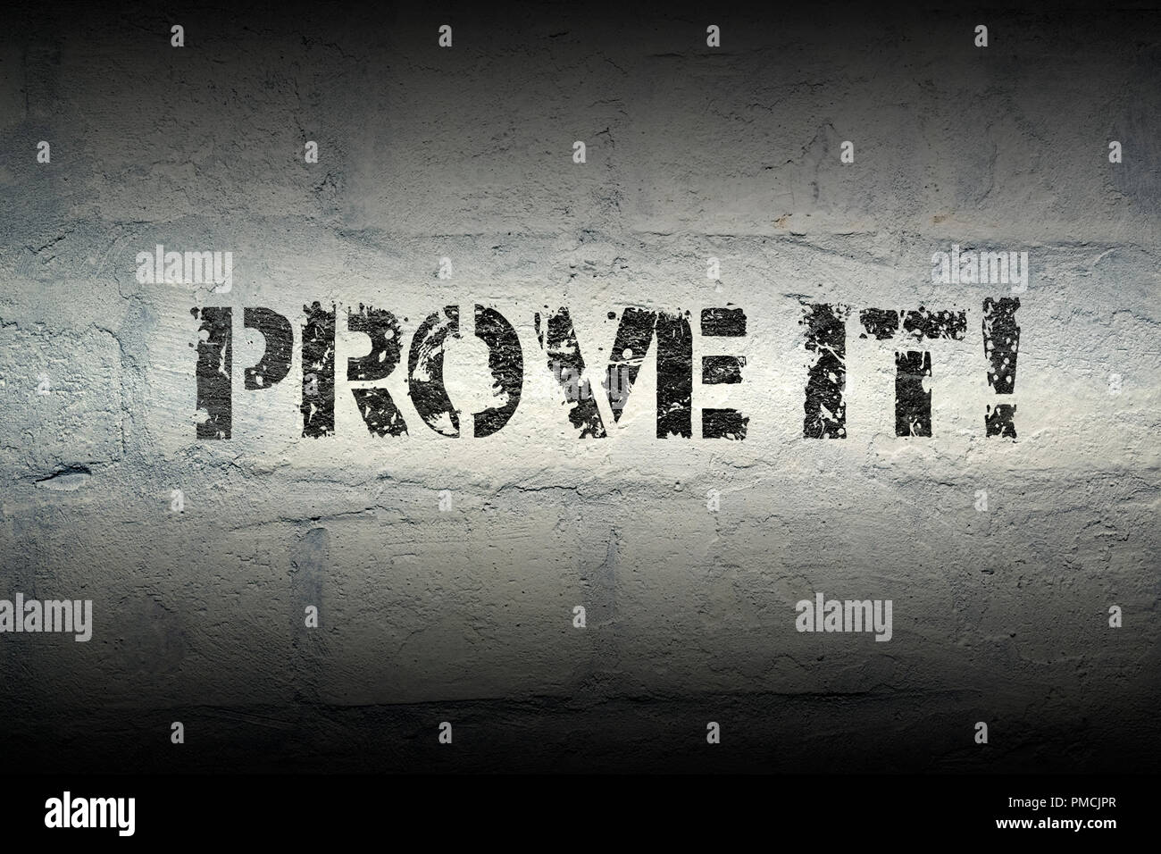 prove it stencil print on the grunge white brick wall Stock Photo - Alamy