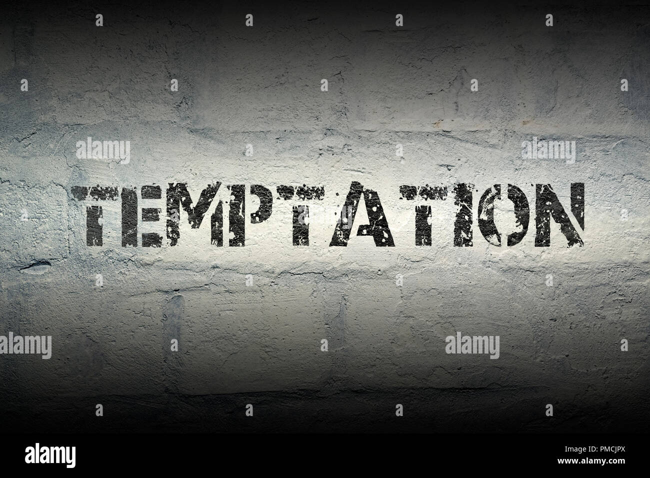 temptation stencil print on the grunge white brick wall Stock Photo - Alamy