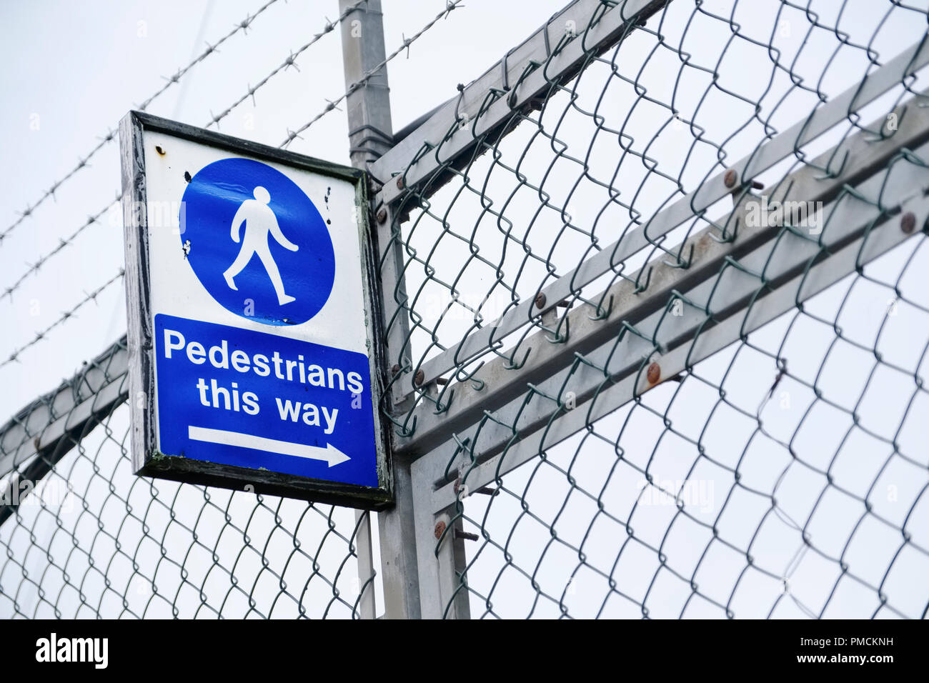 Pedestrians this way sign at entrance to factory and office workplace ...