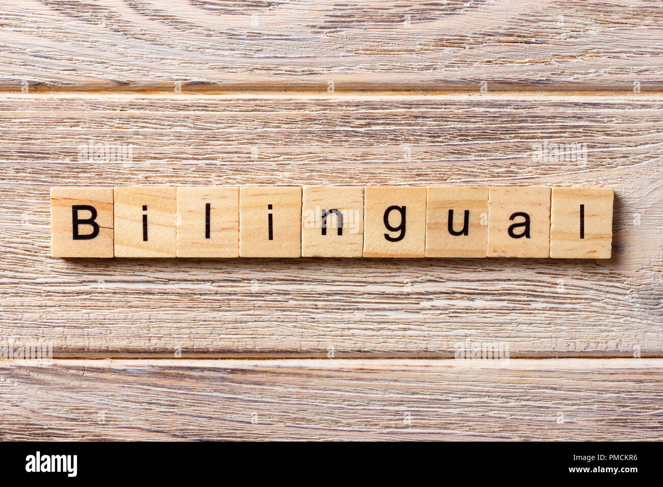 bilingual word written on wood block. bilingual text on table, concept ...